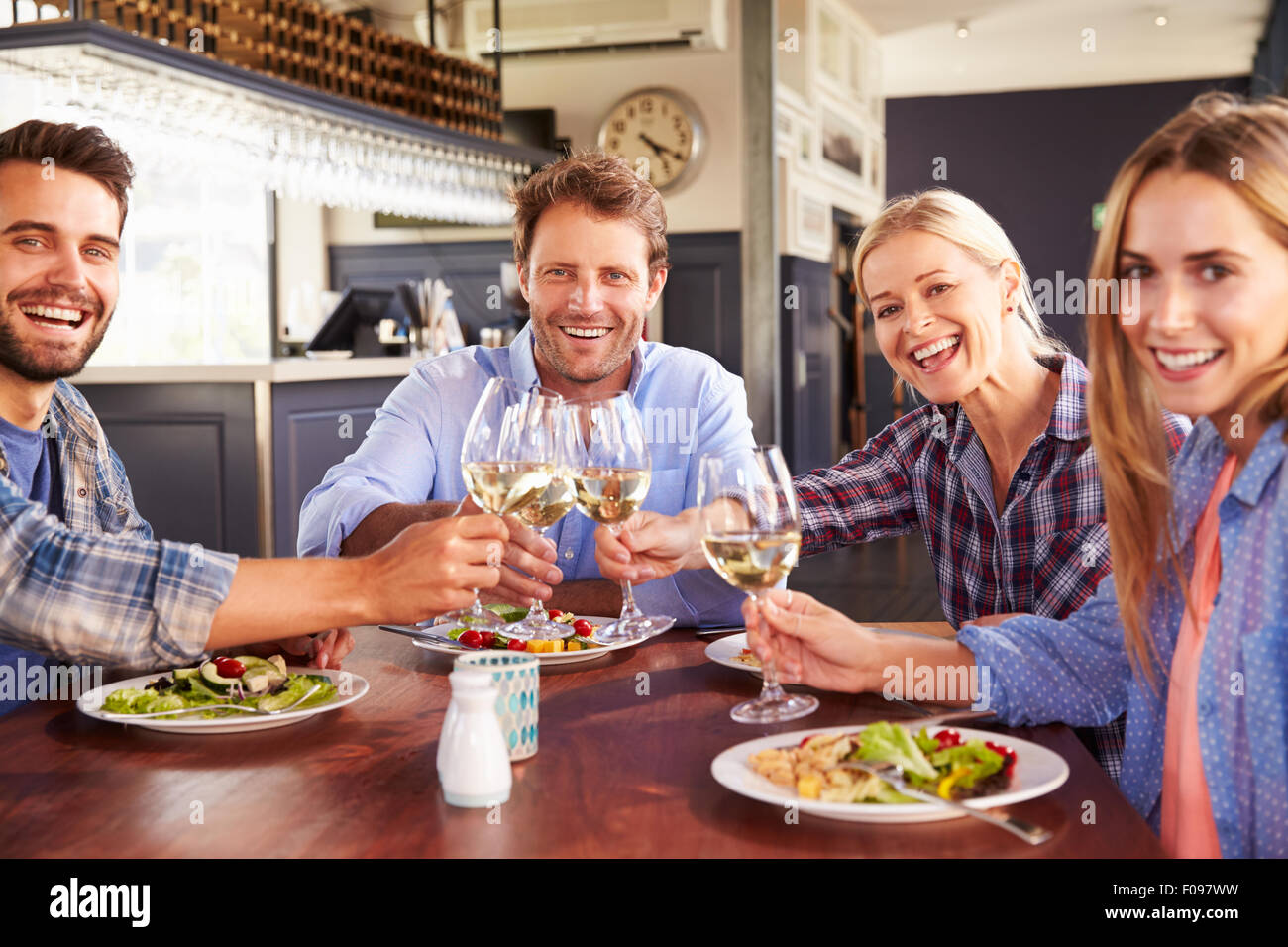 A group of friends making a toast at a restaurant, portrait Stock Photo ...