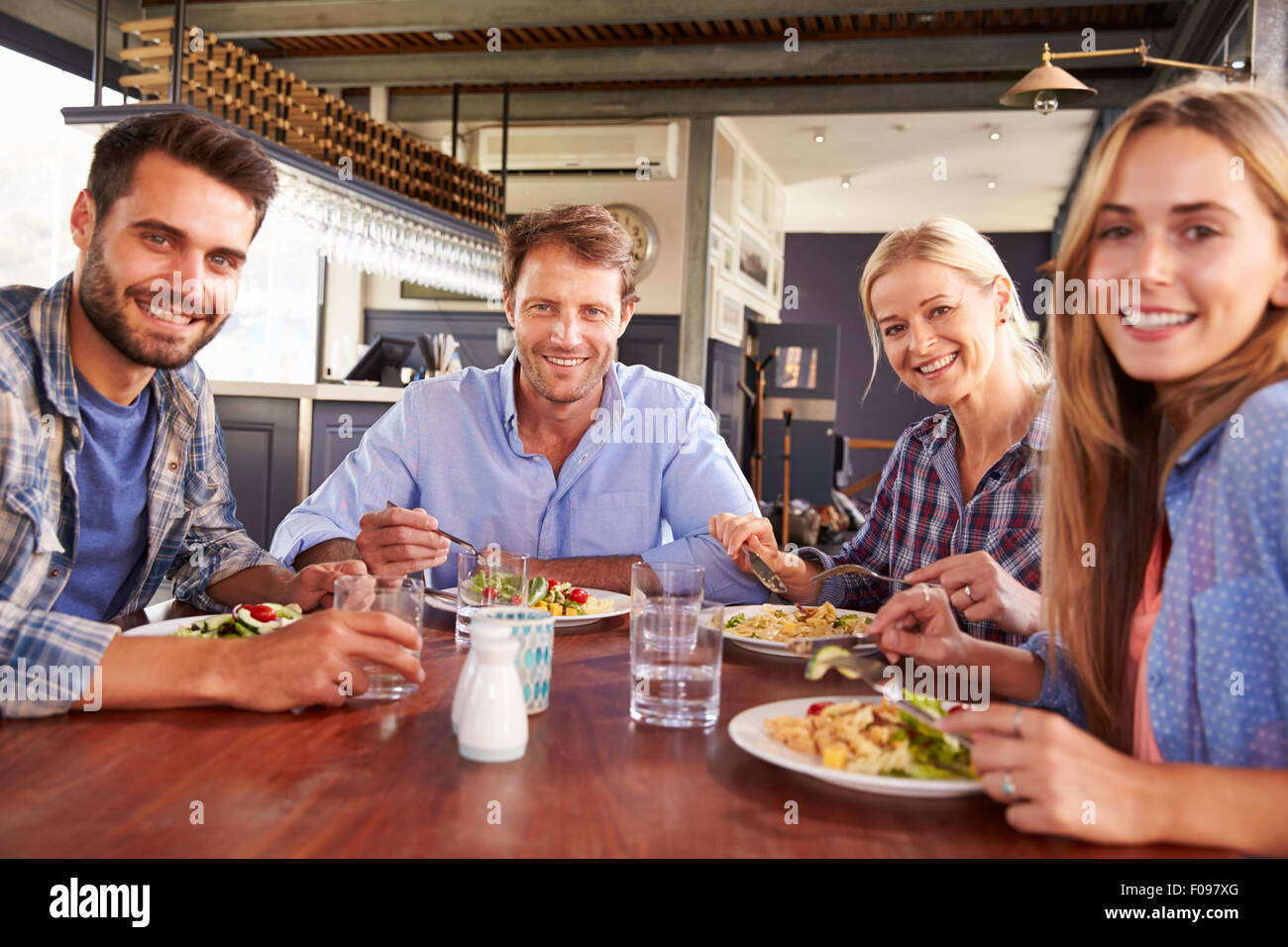A group of friends eating at a restaurant Stock Photo - Alamy