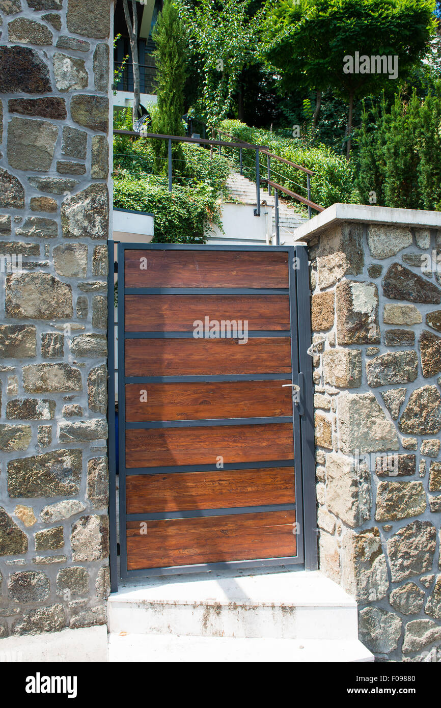 solid gate in a stone fence Stock Photo - Alamy