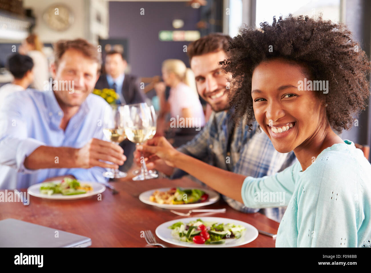 Group of friends at lunch in a restaurant Stock Photo - Alamy