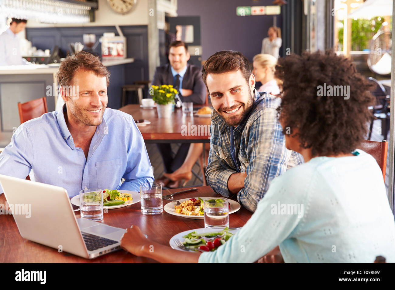 Group of friends at lunch in a restaurant Stock Photo - Alamy