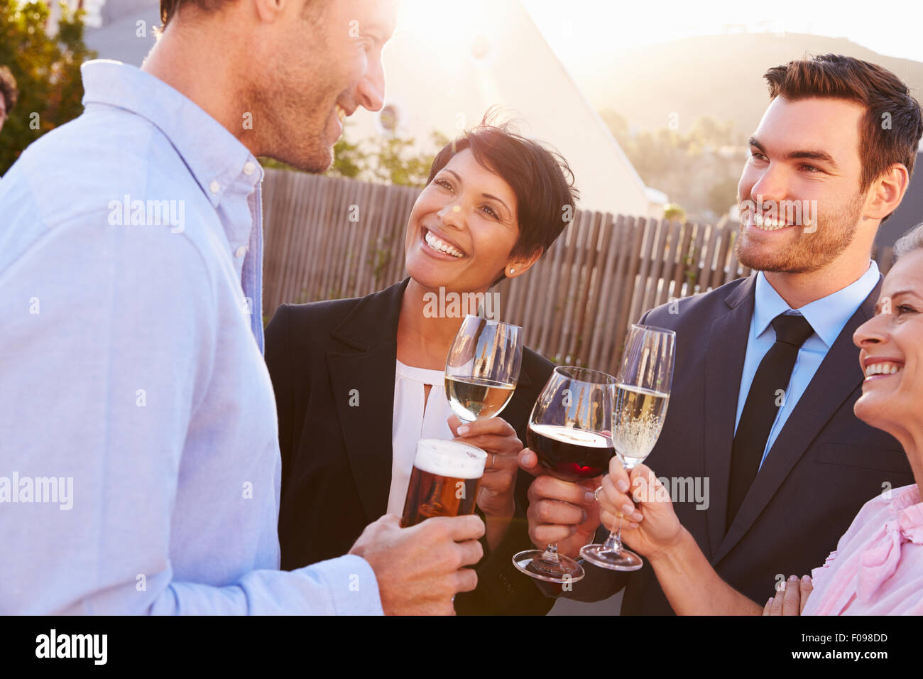 Colleagues drinking after work at a rooftop bar Stock Photo - Alamy