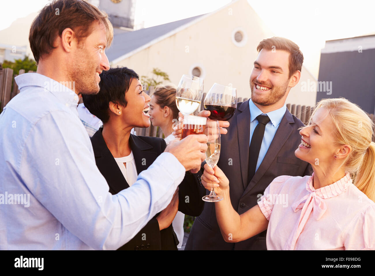 Colleagues drinking after work at a rooftop bar Stock Photo - Alamy