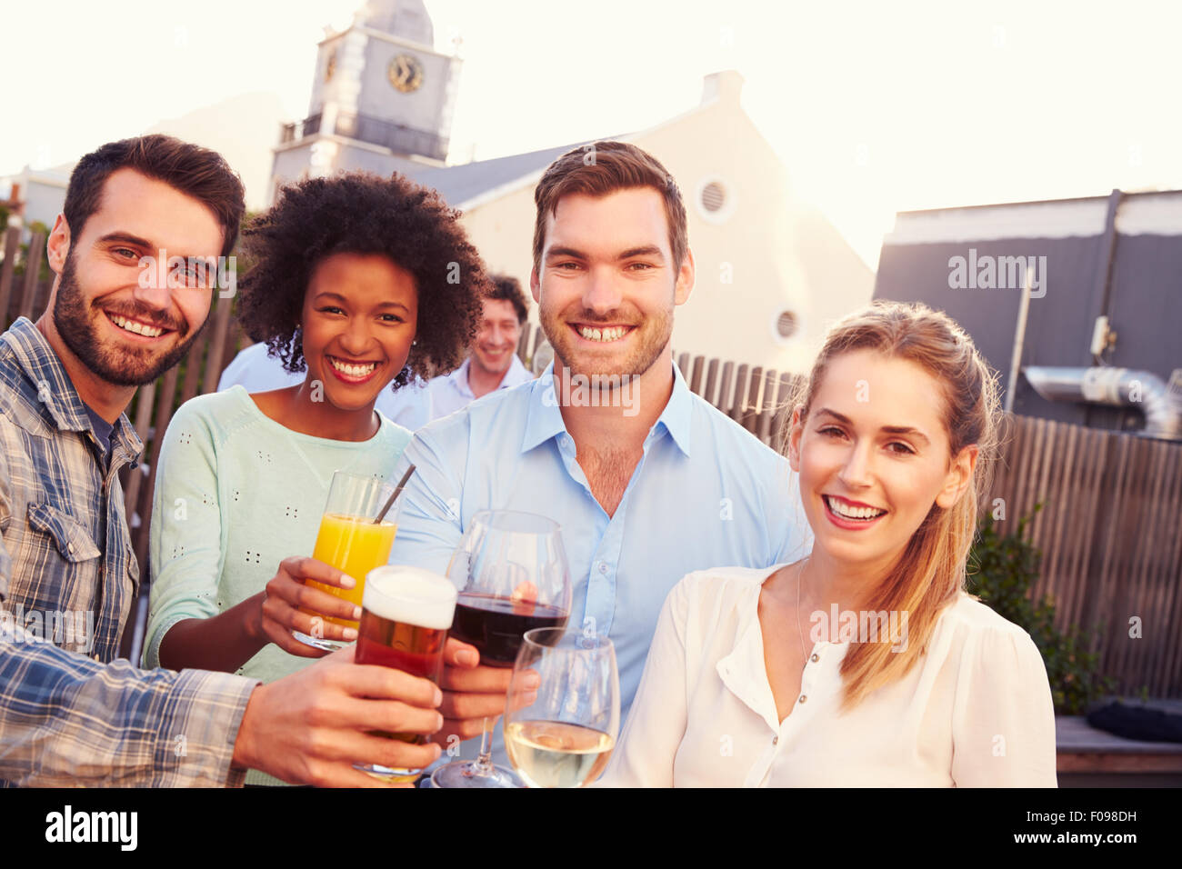 Group of friends drinking at a rooftop bar Stock Photo - Alamy