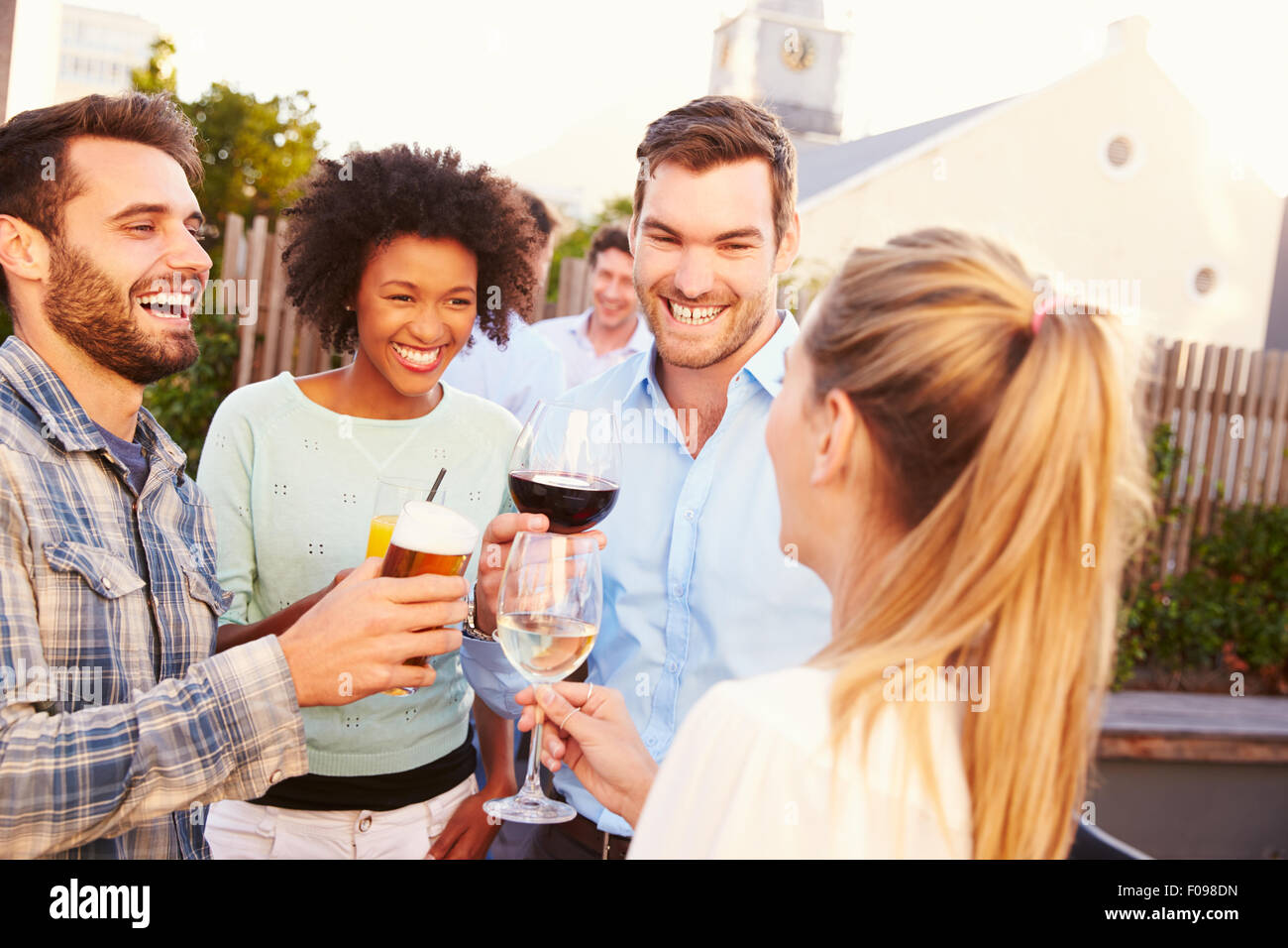 Group of friends drinking at a rooftop bar Stock Photo - Alamy