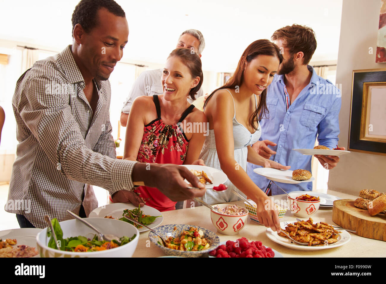 People serving themselves buffet hi-res stock photography and images ...