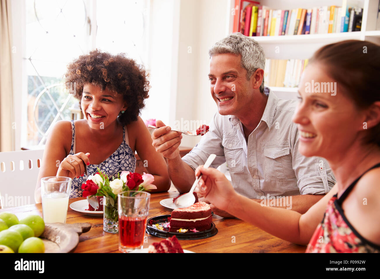 Friends sitting at a table talking during a dinner party Stock Photo ...
