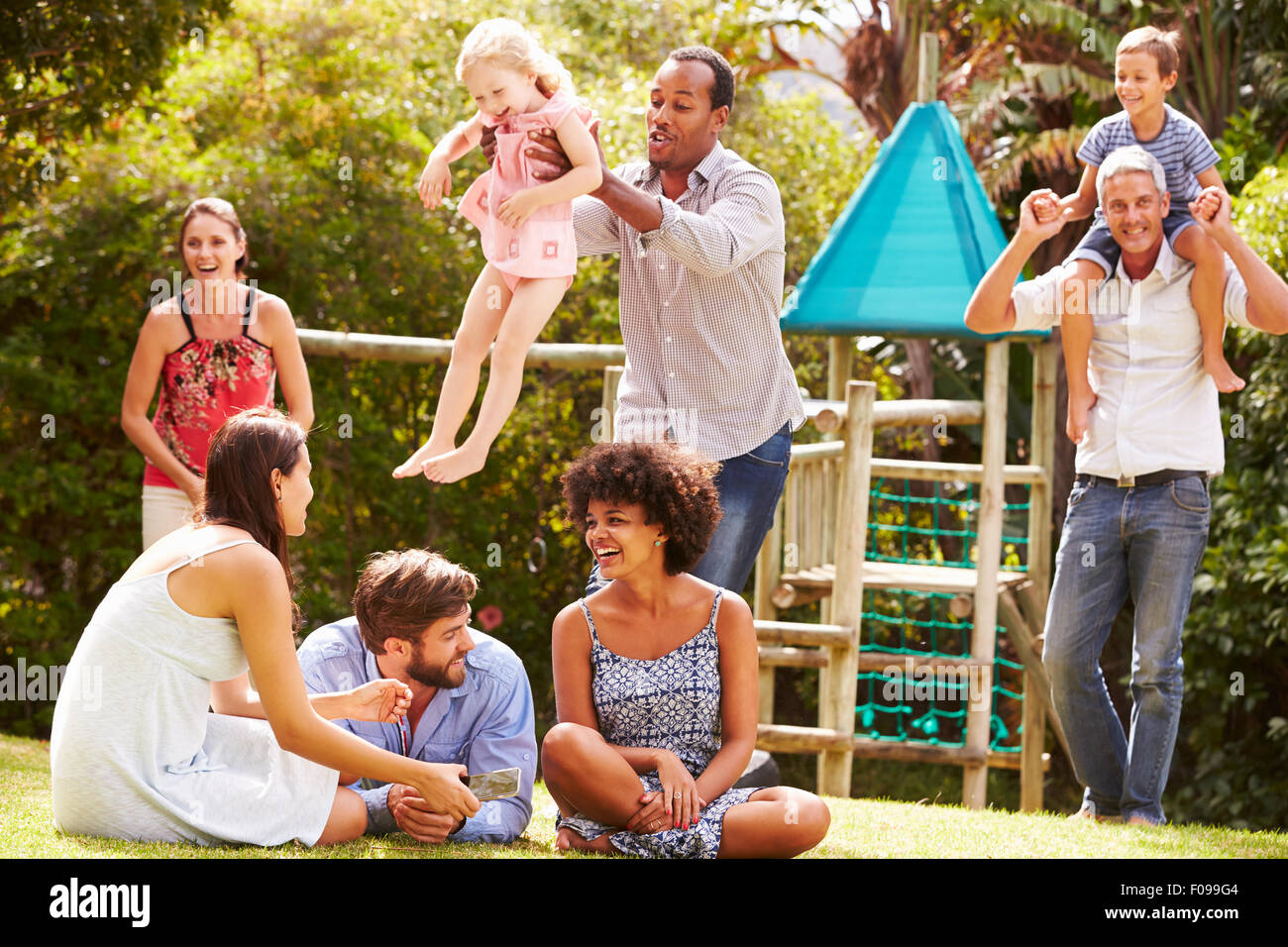 Adults and kids having fun in a garden Stock Photo - Alamy