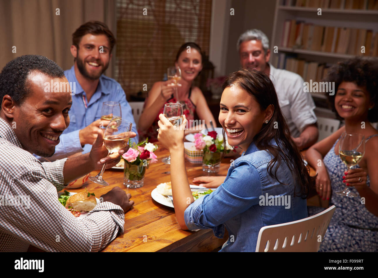 Friends at an evening dinner party, looking at camera Stock Photo - Alamy