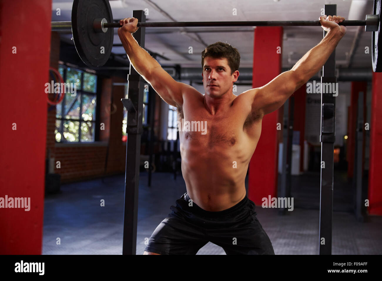Bare Chested Man In Gym Lifting Weights Stock Photo - Alamy