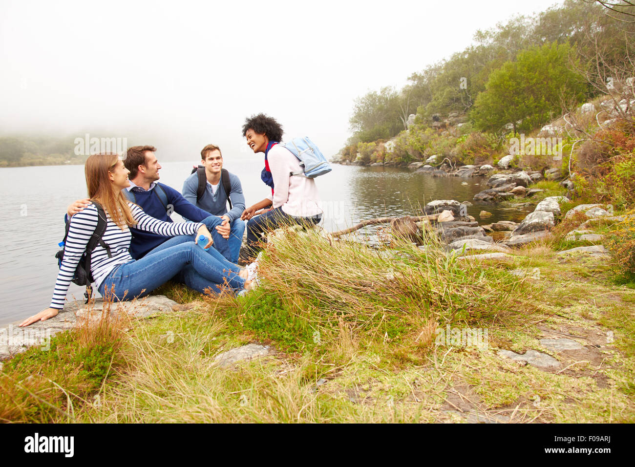 Four people talking hi-res stock photography and images - Alamy