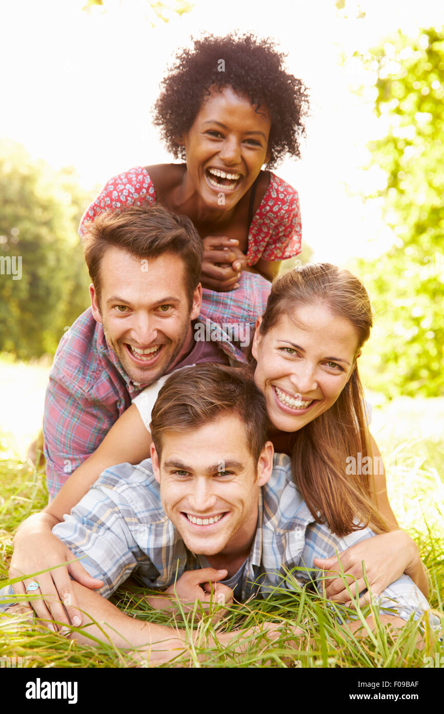 Four friends having fun together in the countryside Stock Photo - Alamy