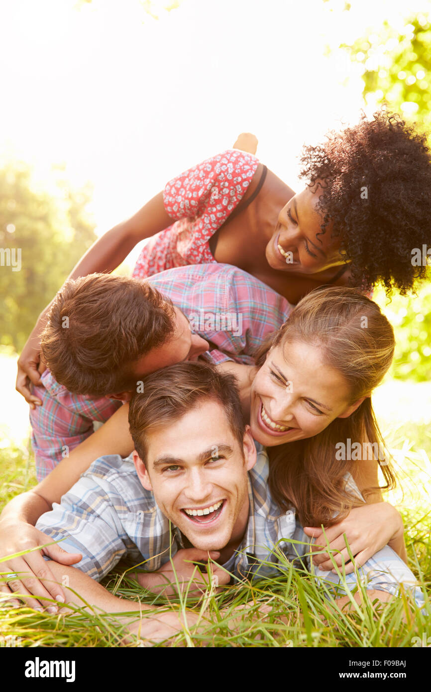 Four friends having fun together in the countryside Stock Photo - Alamy