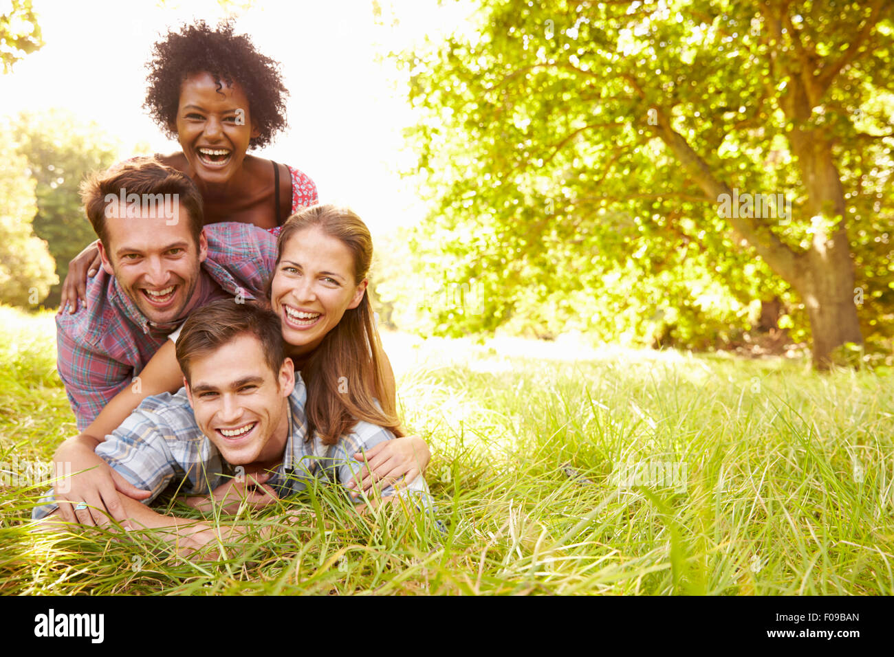 Four friends having fun together in the countryside Stock Photo - Alamy