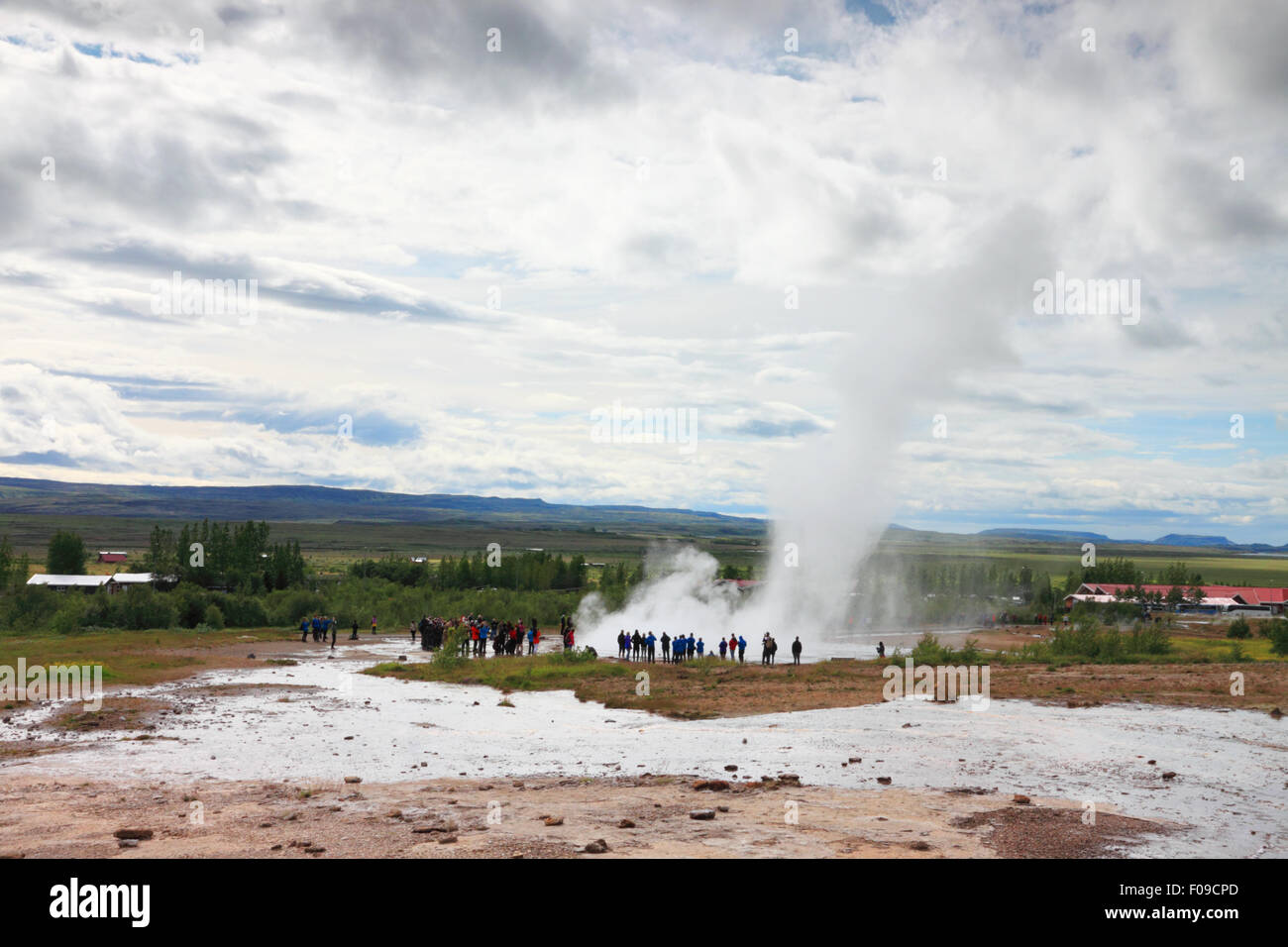 A view of a volcanic hot springs landscape with steaming mud pools ...