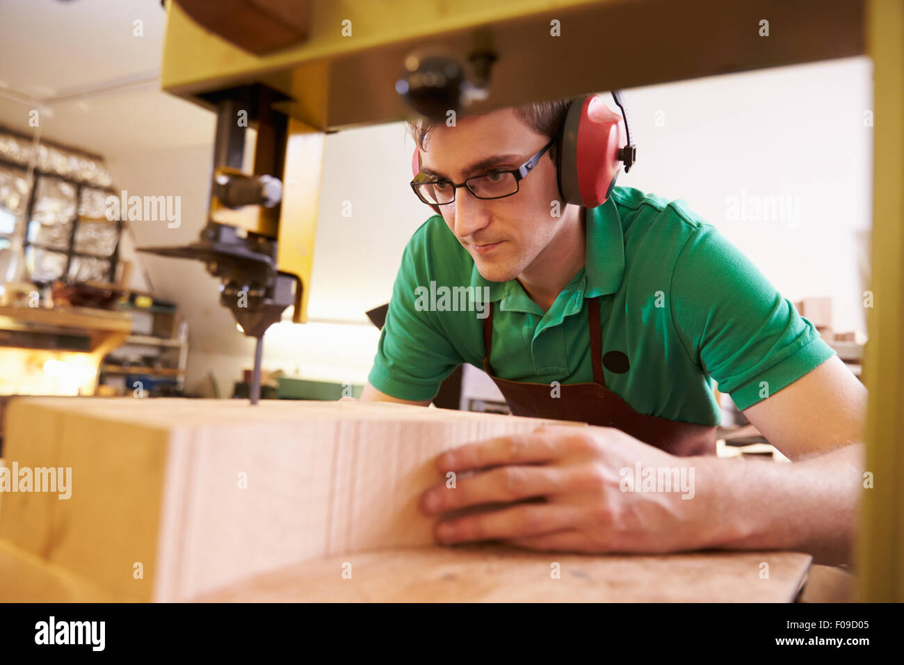 Shoemaker cutting and shaping wood to make shoe lasts Stock Photo - Alamy