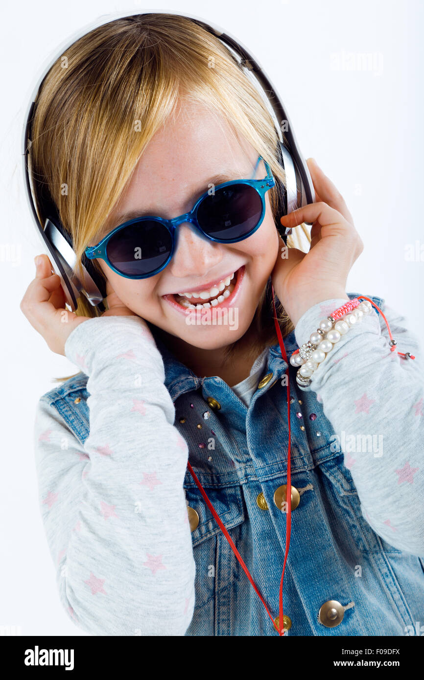 Portrait of beautiful child listening to music with digital tablet ...