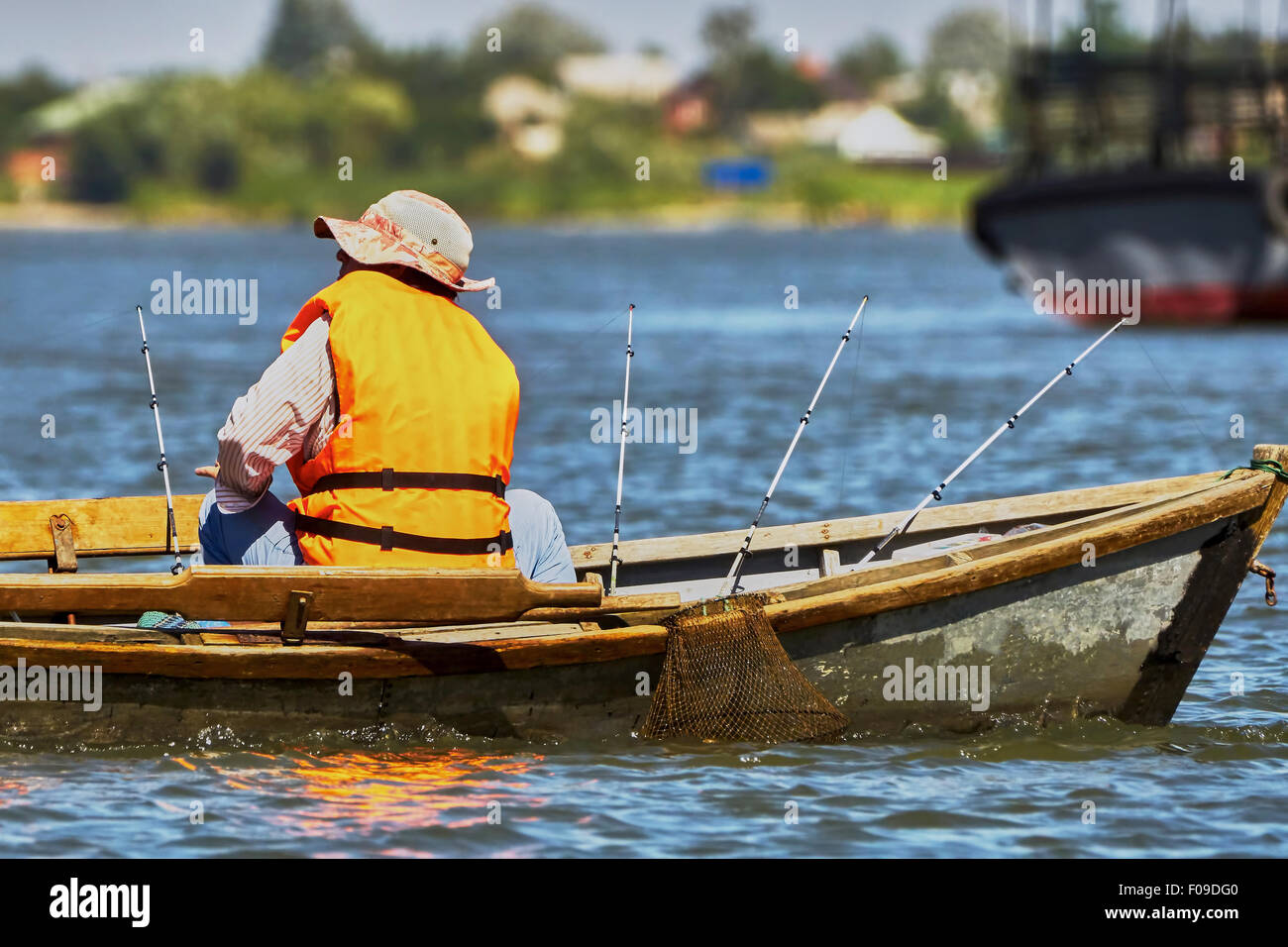 Fisherman in a boat on the water hi-res stock photography and images ...