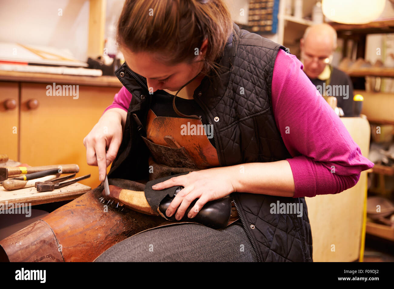 Young shoemaker working in a workshop Stock Photo - Alamy