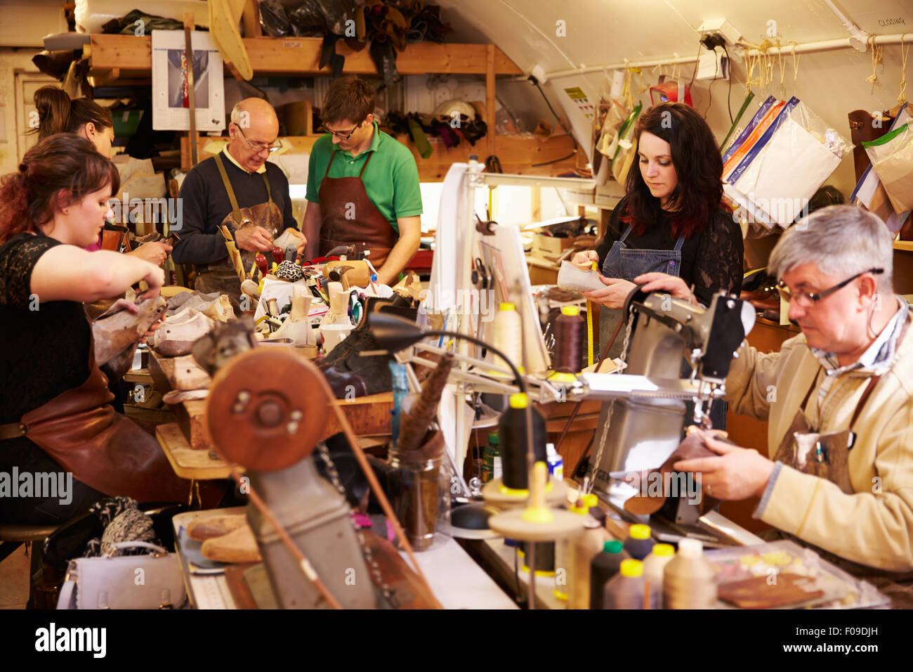 Shoemakers working in a busy workshop Stock Photo - Alamy