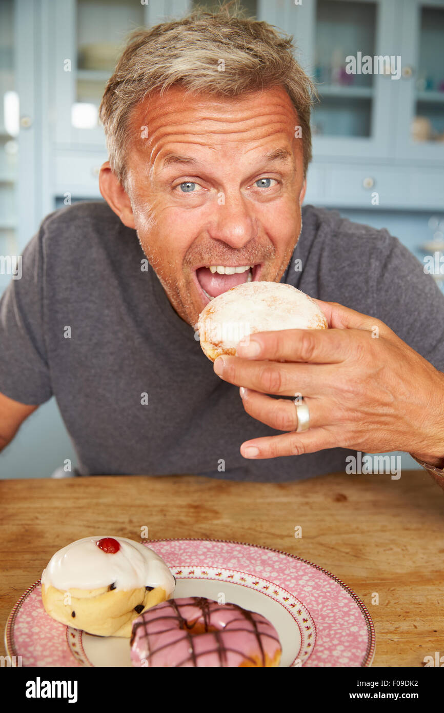 Portrait man eating donut hi-res stock photography and images - Alamy