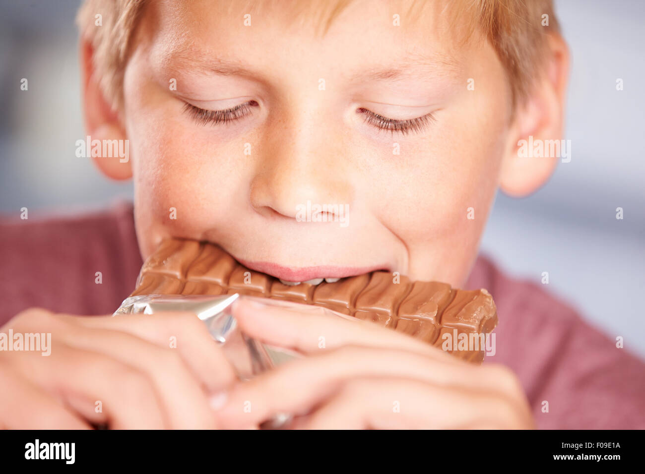 Overweight boy eating junk food hi-res stock photography and images - Alamy