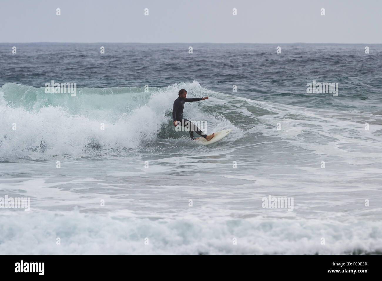 Pfeiffer Beach, California - May 01 : Male surfer in a full suit ...