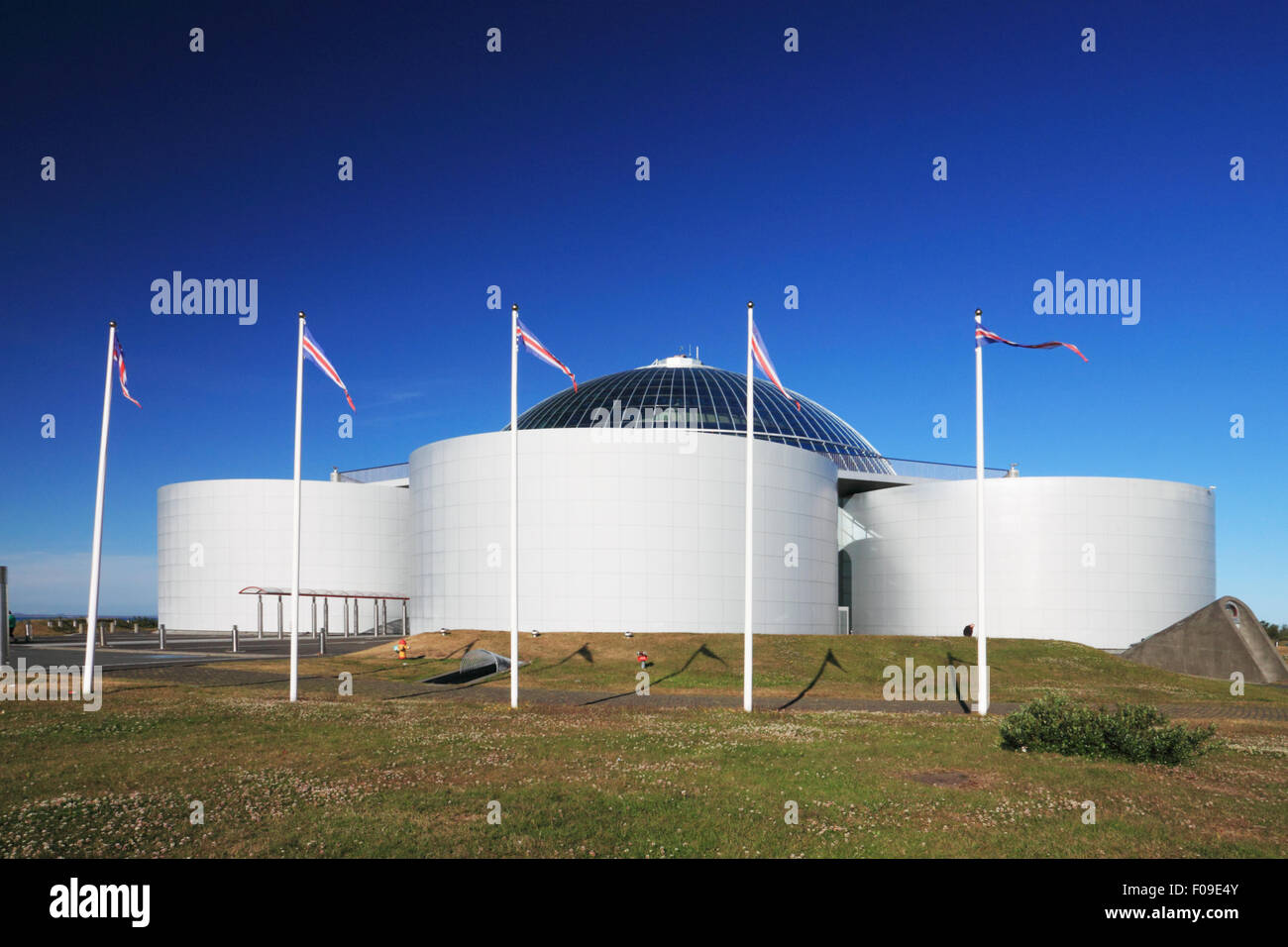 A group of cylindrical metal tanks with flags and deep blue sky Stock ...