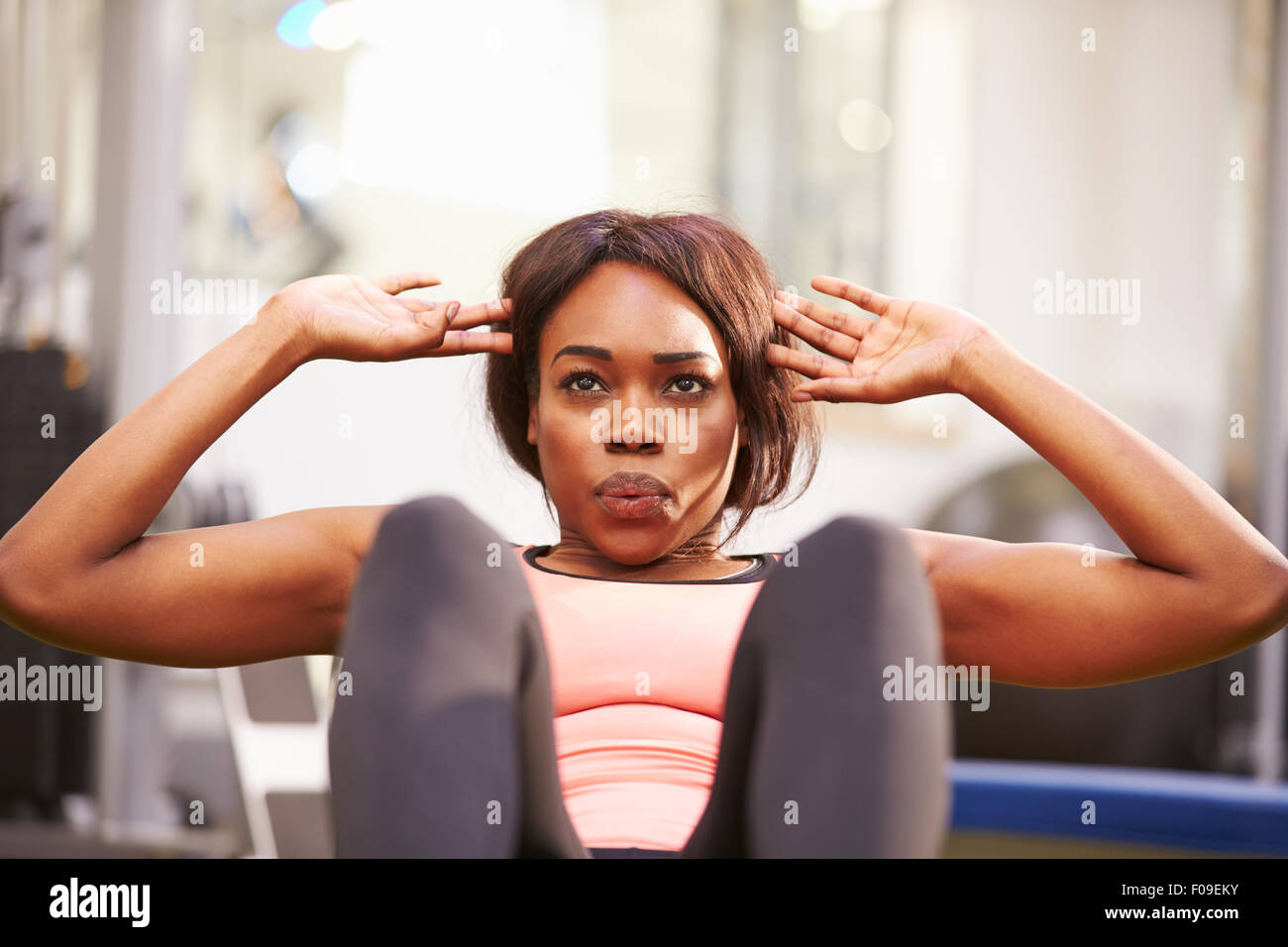 Young woman doing crunches in a gym, close up Stock Photo - Alamy