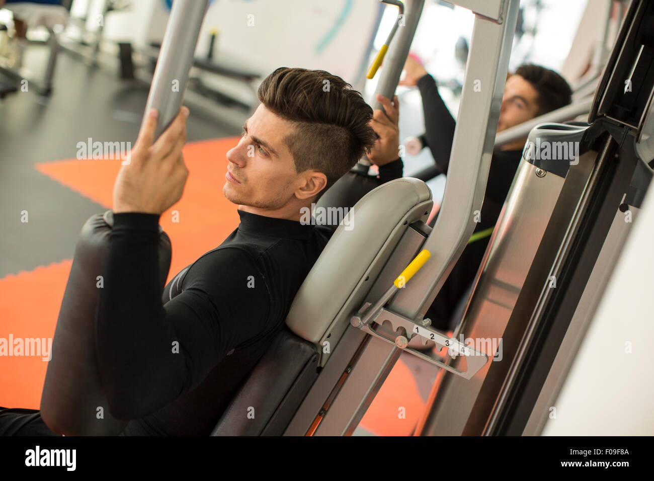 Young man training in the gym Stock Photo - Alamy