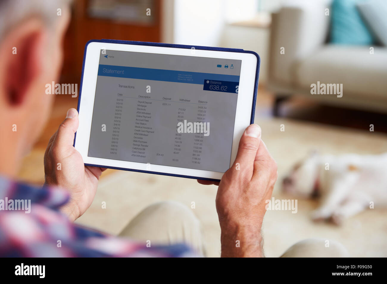 Man Looking At Banking App On Digital Tablet Stock Photo - Alamy