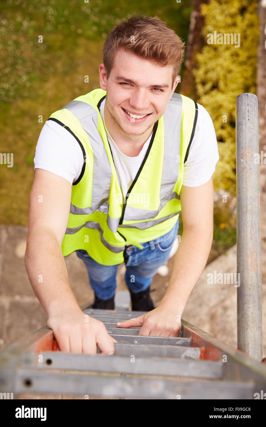 Construction Worker Climbing Ladder On Building Site Stock Photo - Alamy