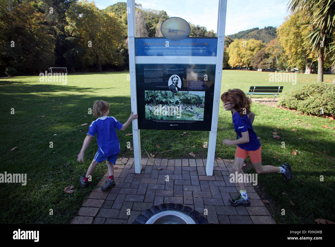 two children run around the sign telling of the first game of rugby to ...