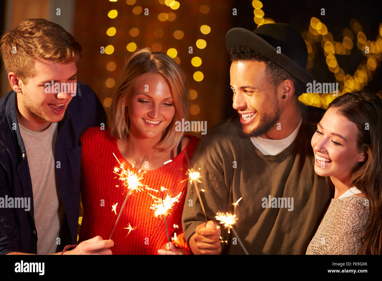 Group Of Friends Lighting Sparklers At Outdoor Party Stock Photo - Alamy