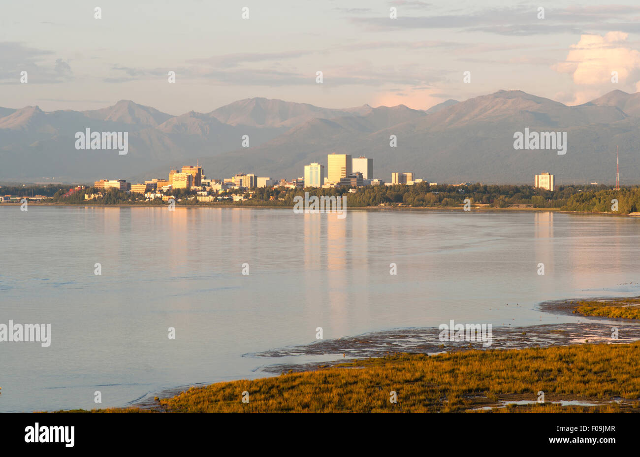 A pink sunset reflects light on the buildings and water Stock Photo - Alamy