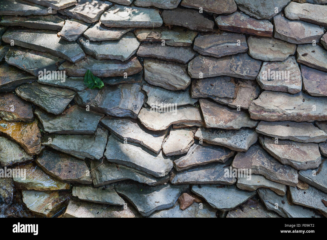 decorative uneven cracked real stone wall surface with cement ...