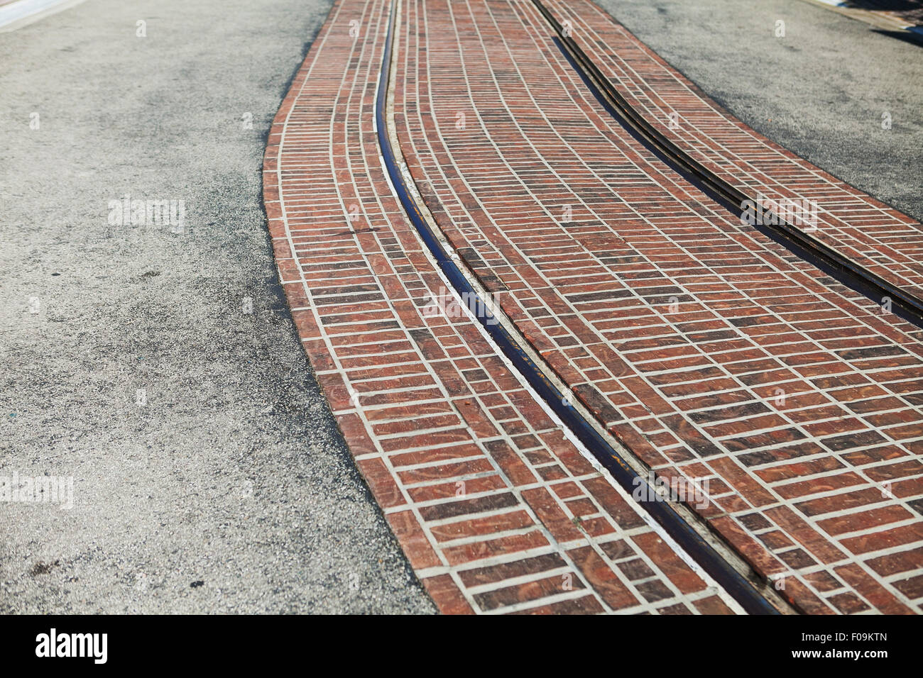 Old tram railways closeup. Tram rails and brick slats at tram stop ...