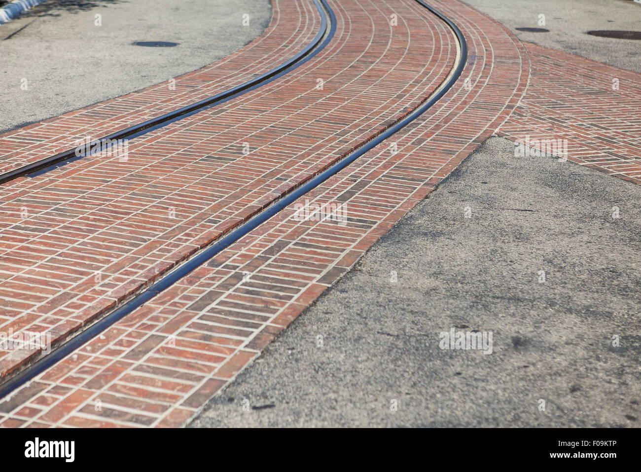 Bending old tram rails. Tram rails and brick slats at tram stop Stock ...
