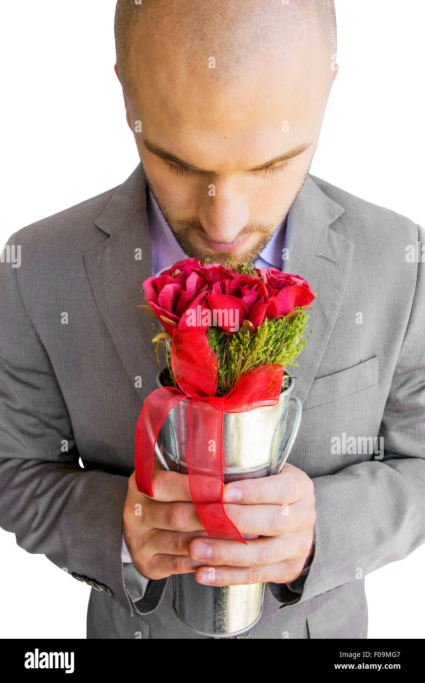 Man in suit holding bouquet of red roses in a vase Stock Photo - Alamy