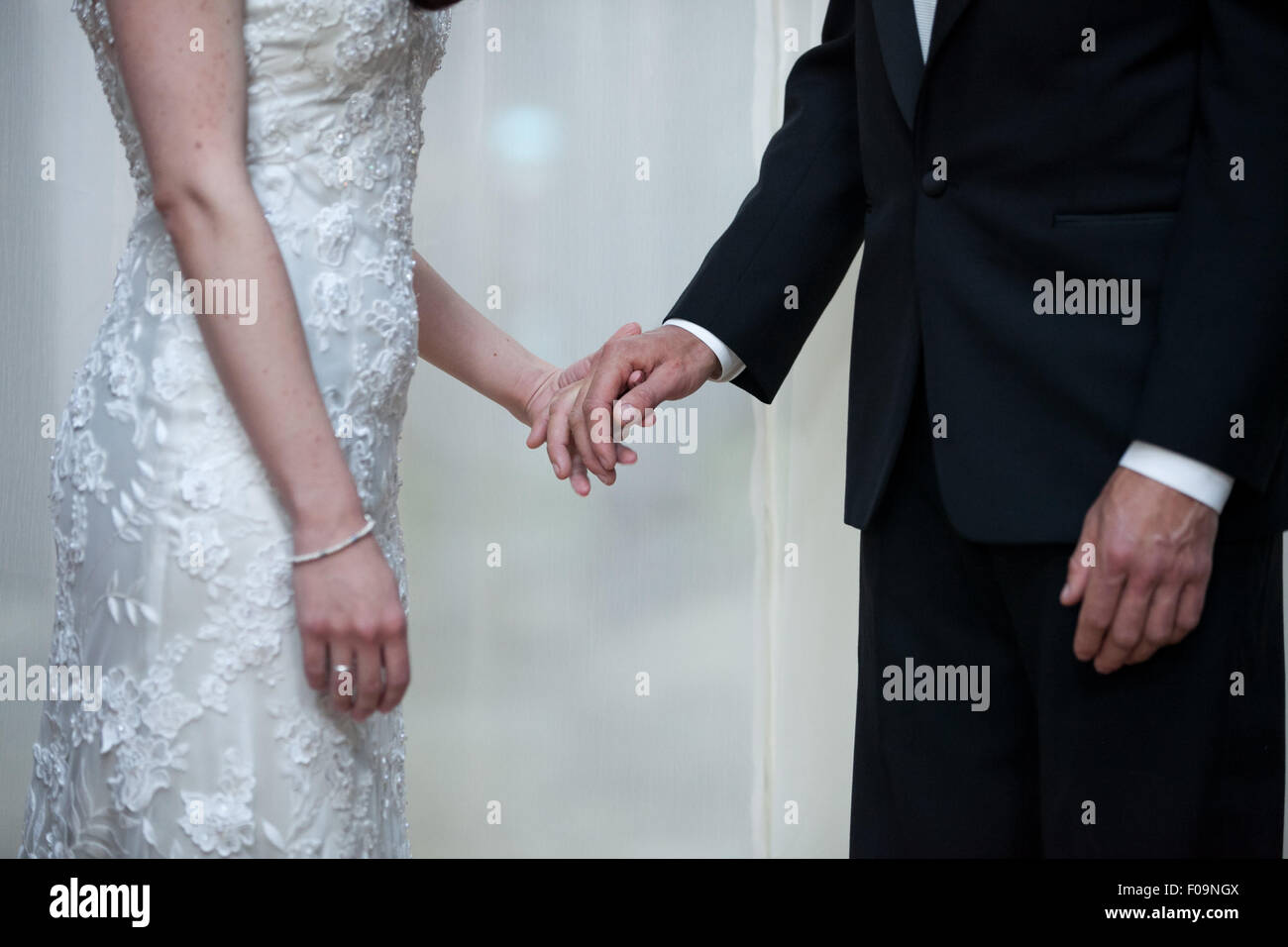 Bride and groom holding hands during a wedding ceremony Stock Photo - Alamy