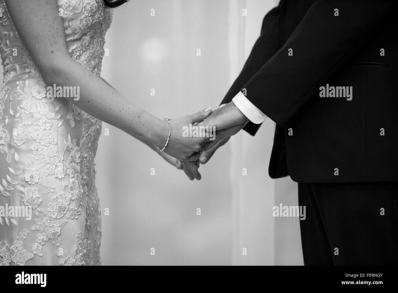 Bride and groom holding hands during a wedding ceremony Stock Photo - Alamy