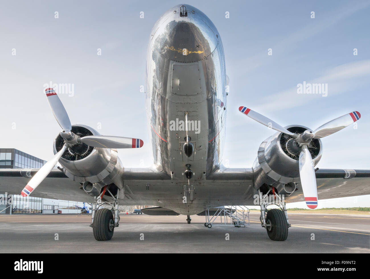 Silver coloured shiny plane with Norway flags on its two propellers ...