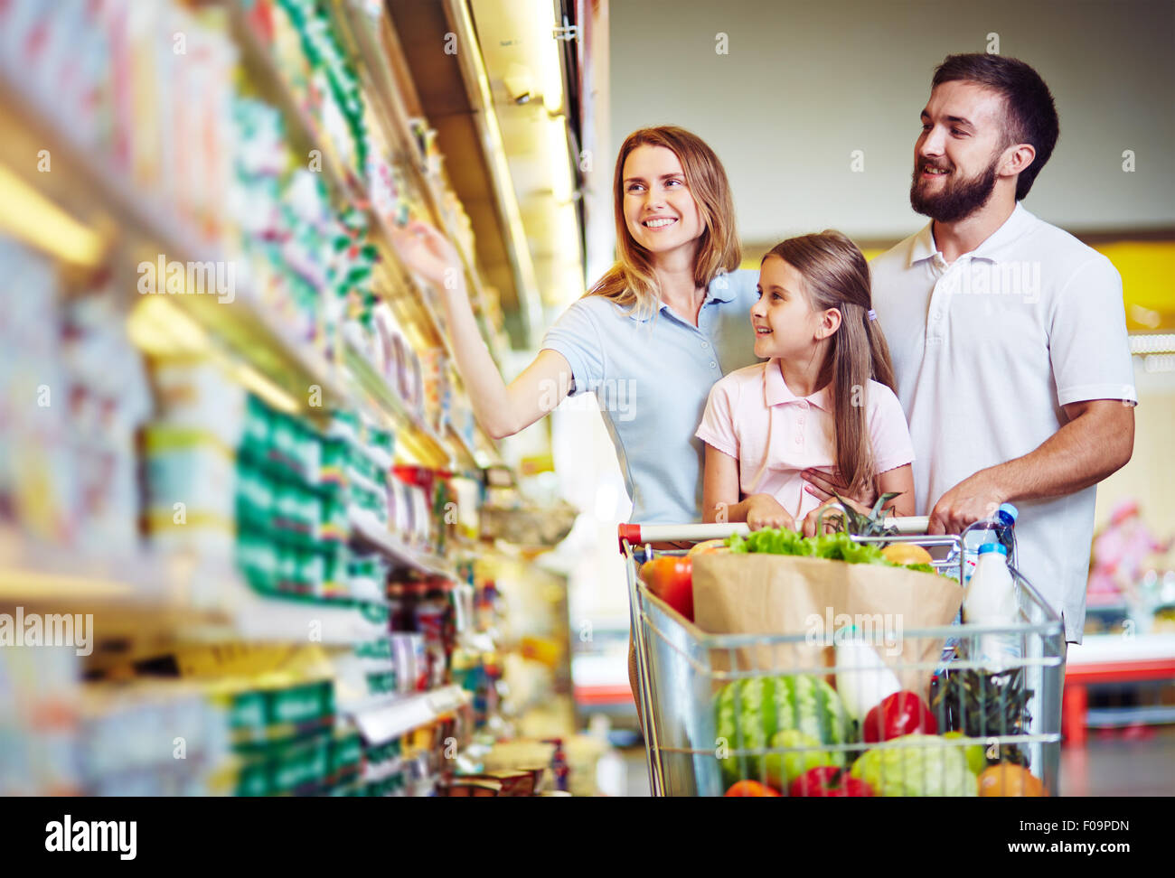 Happy family choosing dairy products in supermarket Stock Photo - Alamy