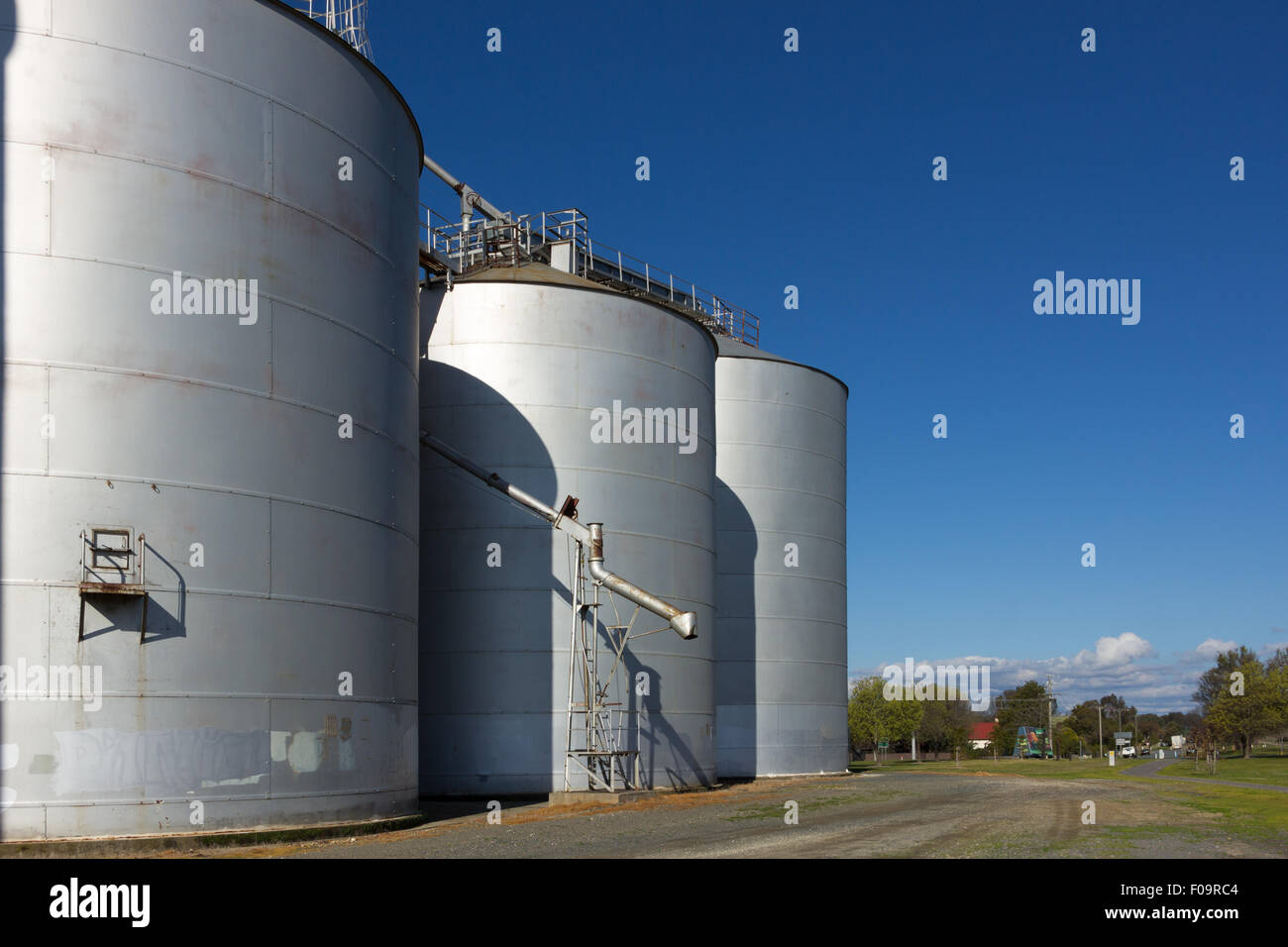 Large silos on a clear day, with drop pipe showing Stock Photo - Alamy