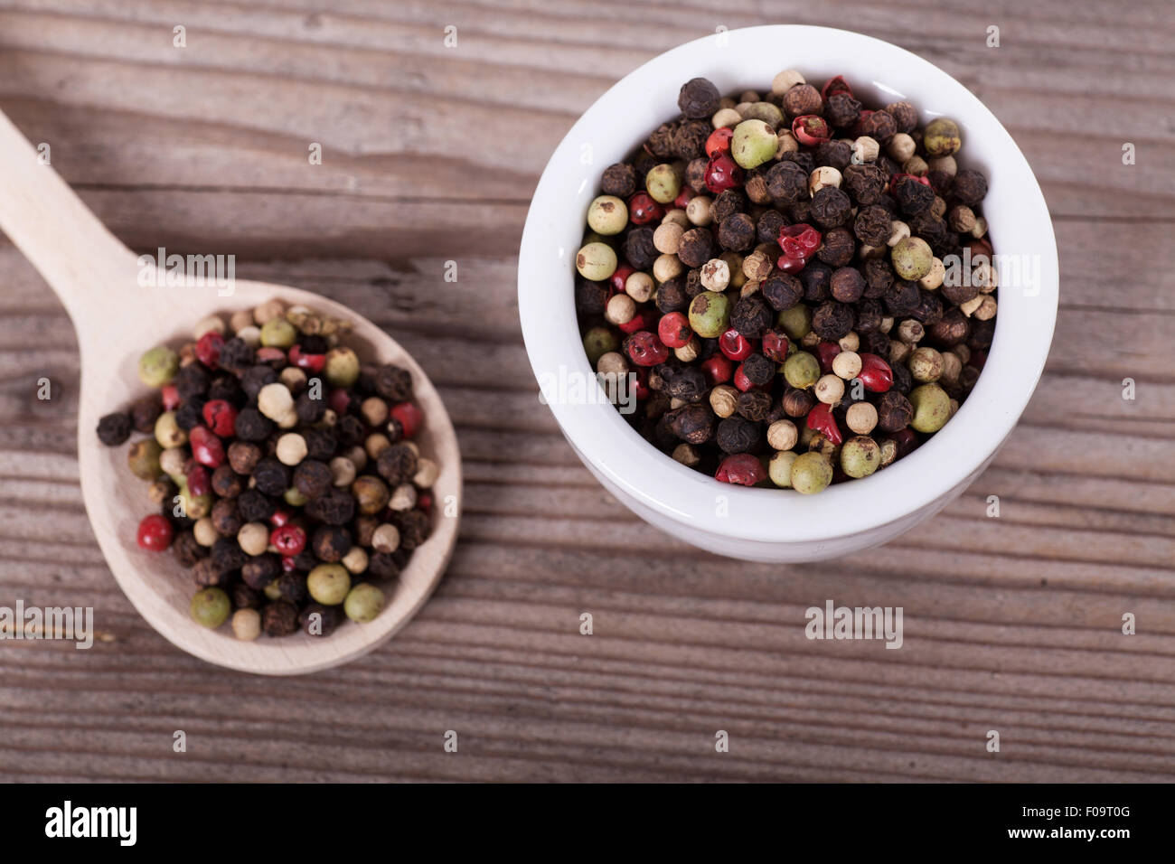 Pepper mixture on spoon over wooden background Stock Photo - Alamy