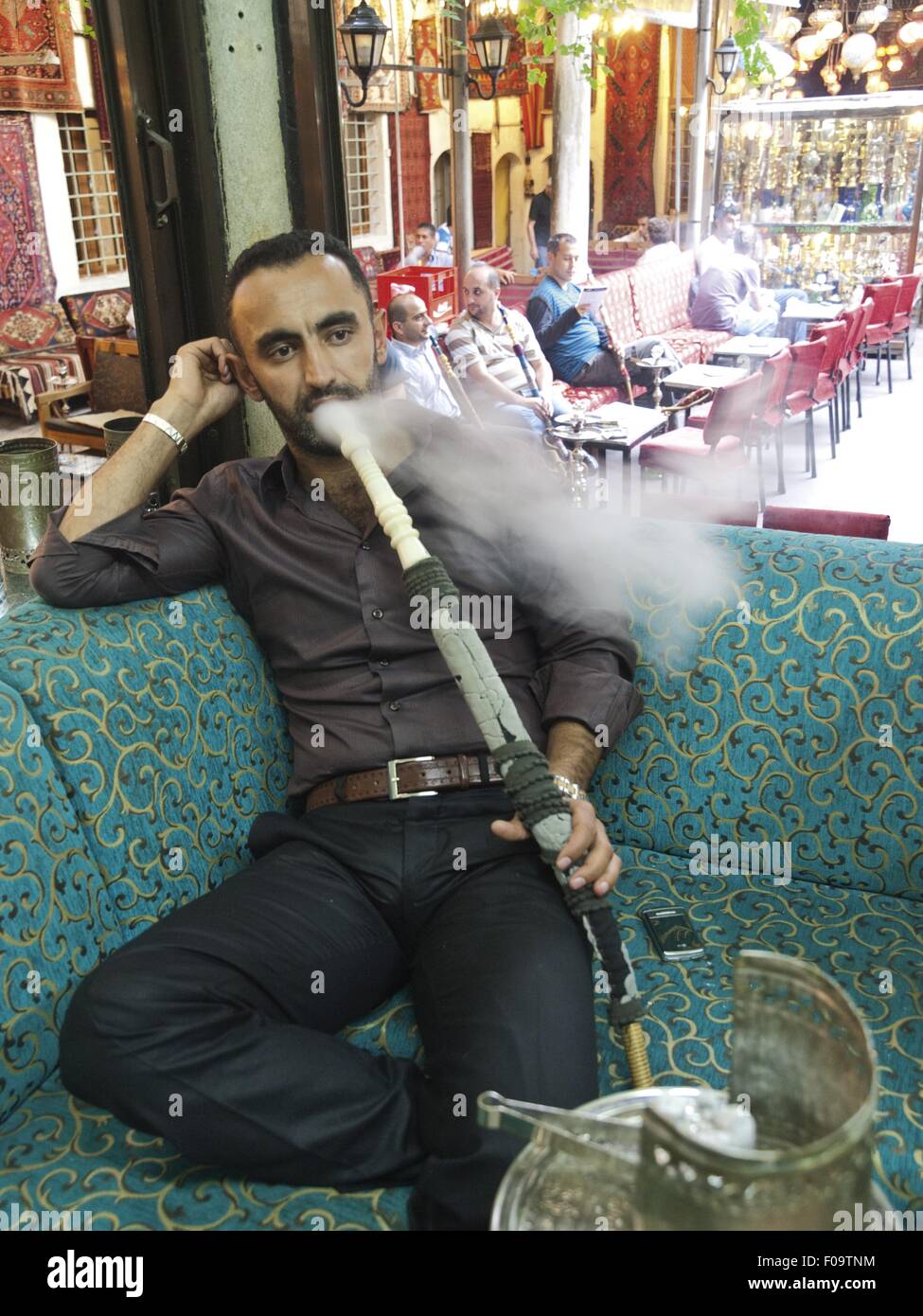 Man smoking hookah in Grand Bazaar, Eminonu, Istanbul Stock Photo - Alamy