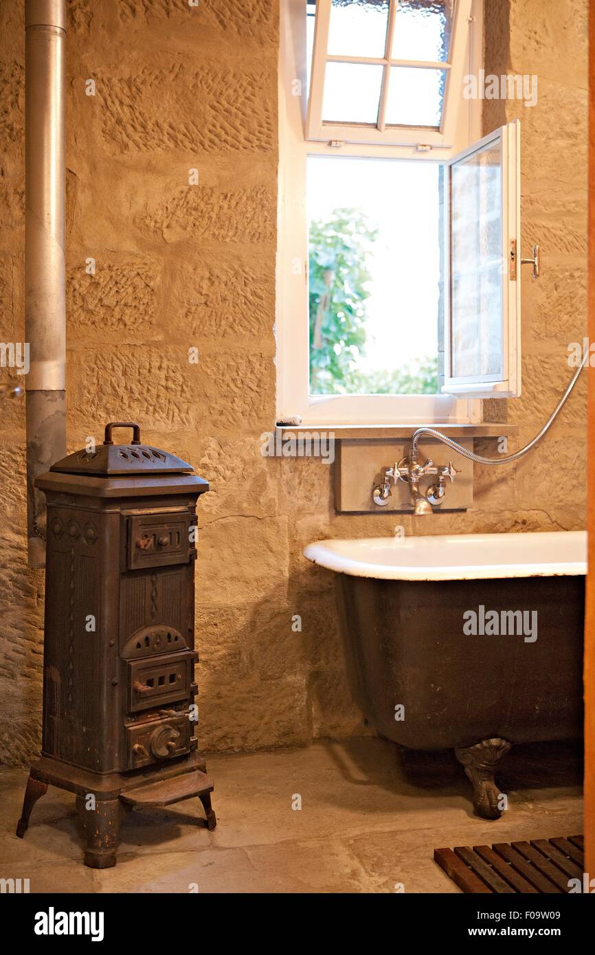 Old fashioned bathroom with, stove, sink and bathtub Stock Photo - Alamy