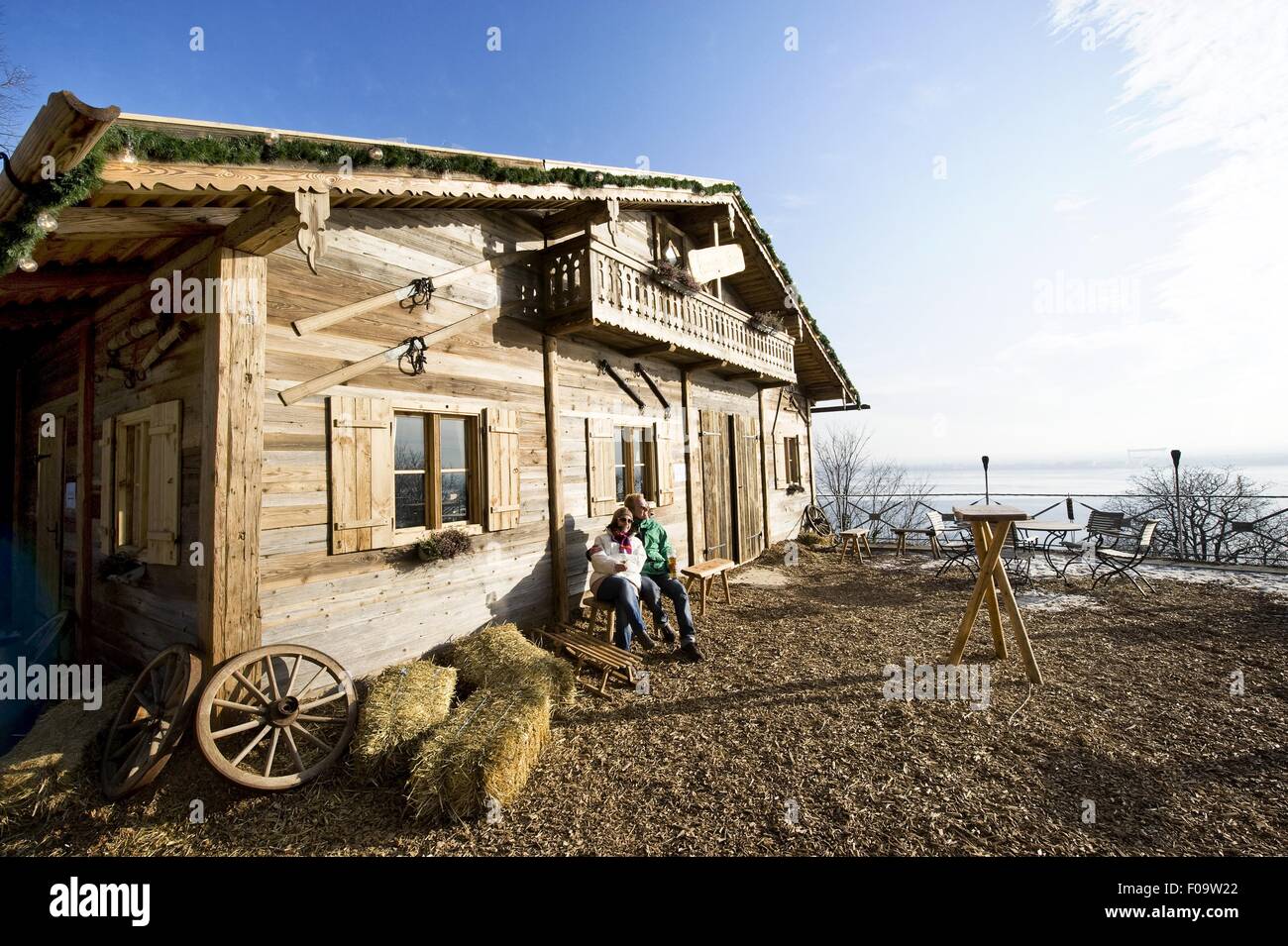Couple sitting outside hut at Hamburg, Germany Stock Photo - Alamy