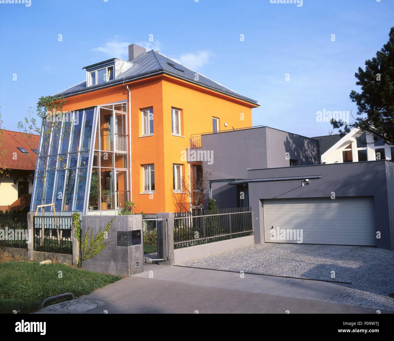 Villa in orange with conservatory glass in front Stock Photo - Alamy