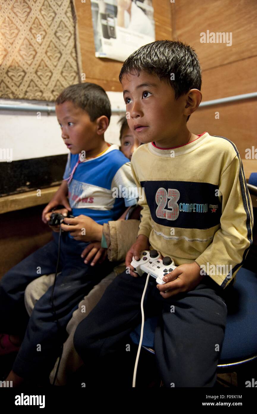 Children having fun while playing Playstation in Buthan Stock Photo - Alamy